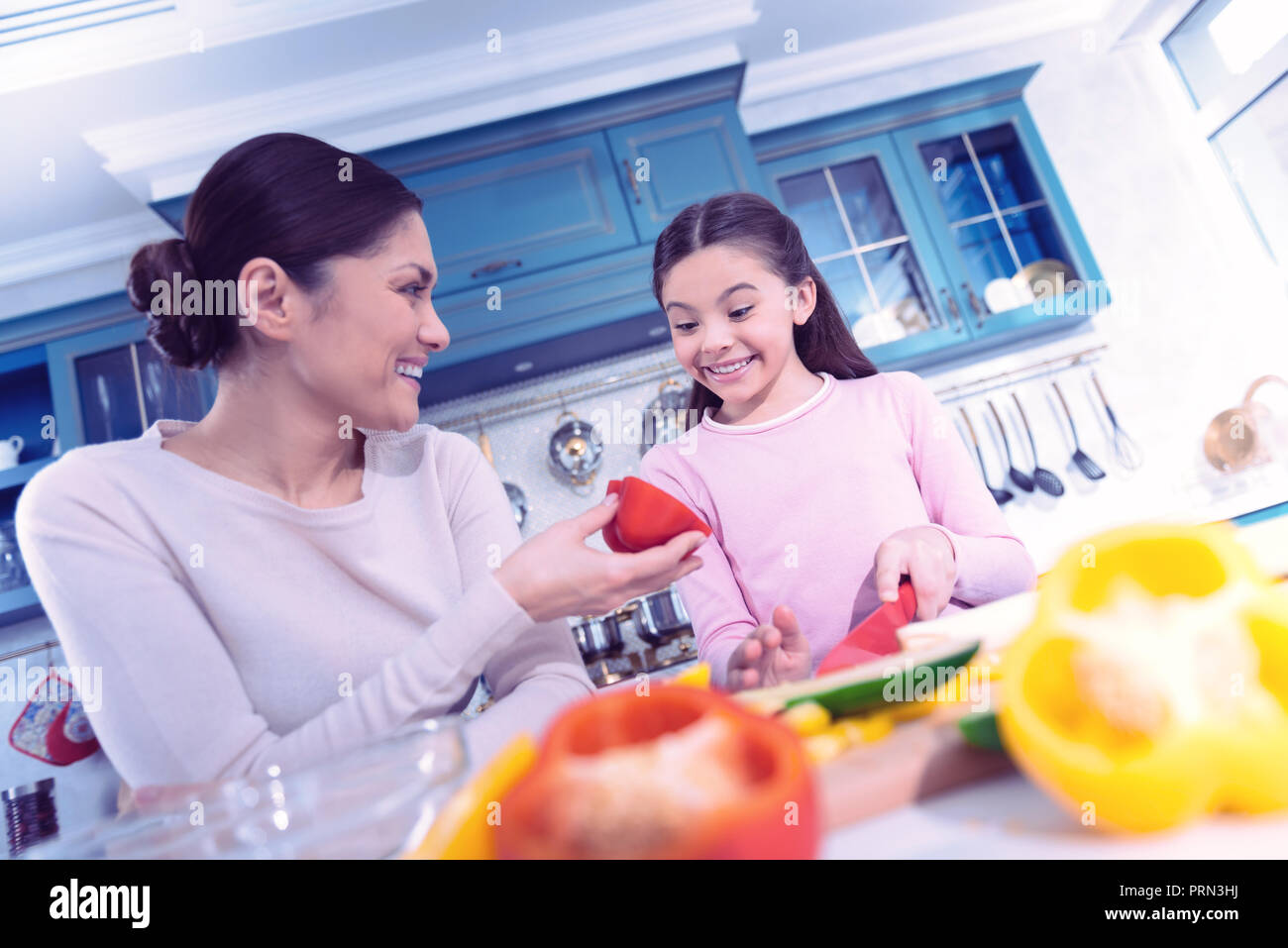 Emotional girl feeling excited while cooking with mother Stock Photo ...