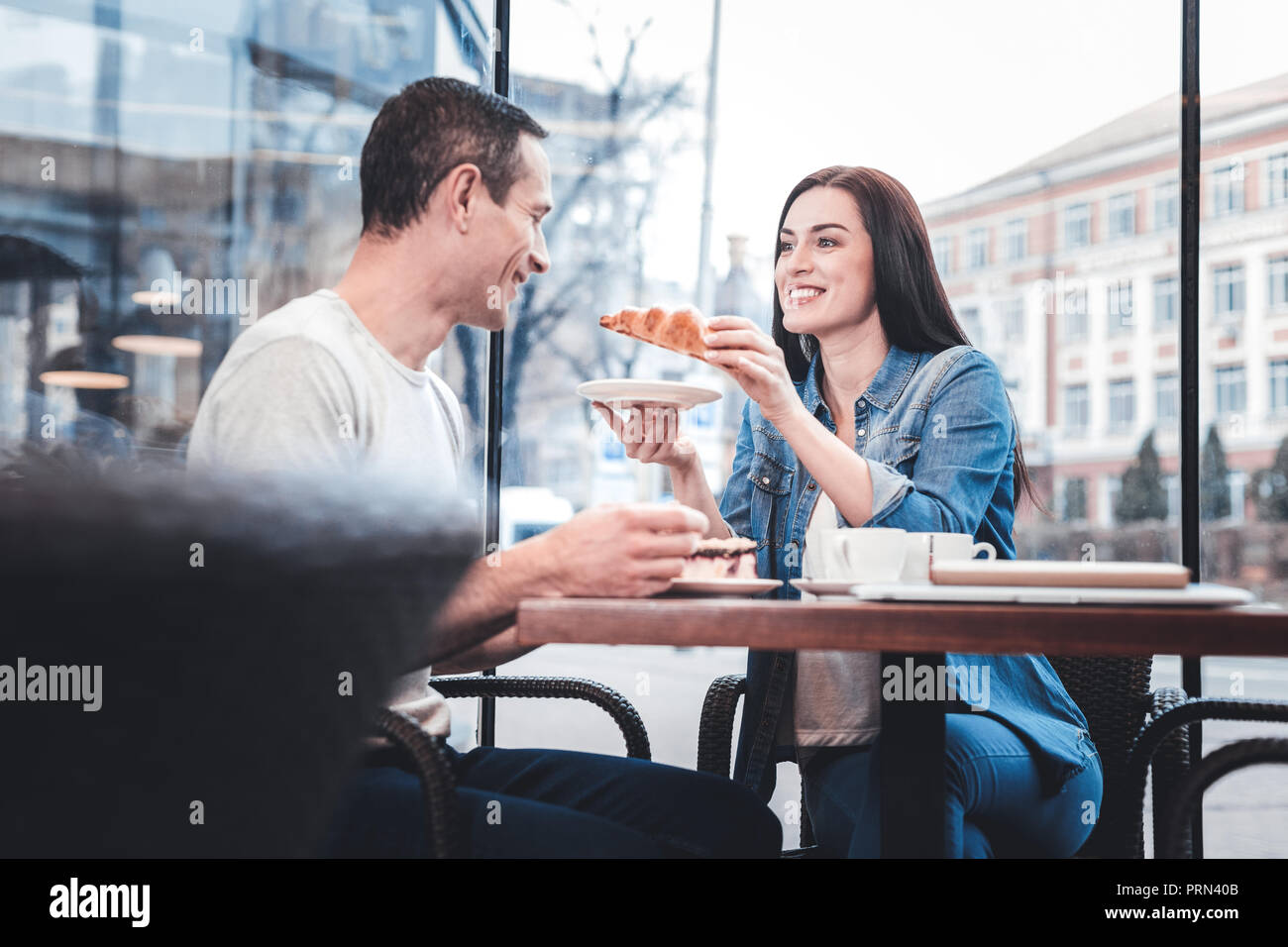 Beautiful woman feeding her boyfriend Stock Photo - Alamy