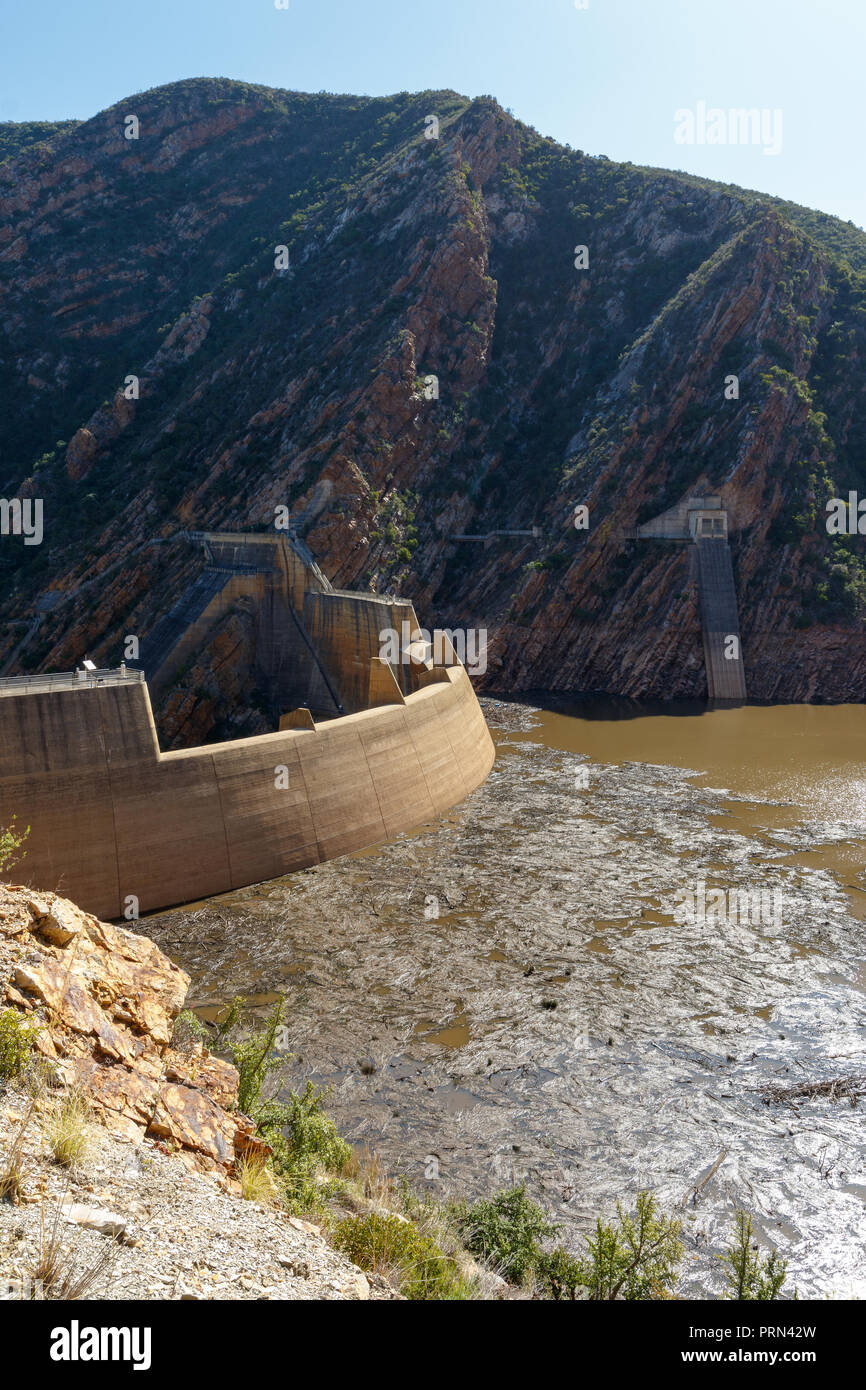 The dam wall built next to the mountains with water flowing Stock Photo ...