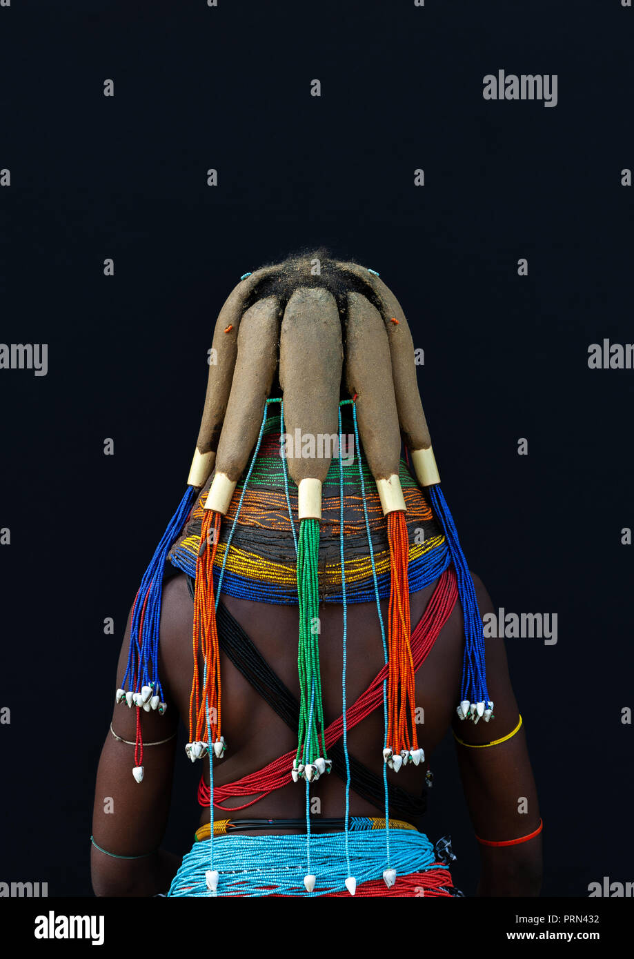 Rear view of a Mumuhuila tribe woman, Huila Province, Chibia, Angola ...