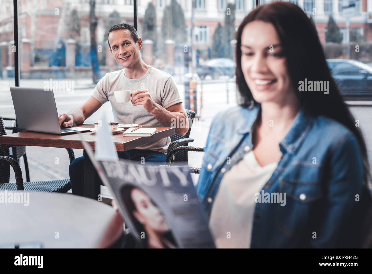 Positive delighted man flirting to pretty girl Stock Photo - Alamy