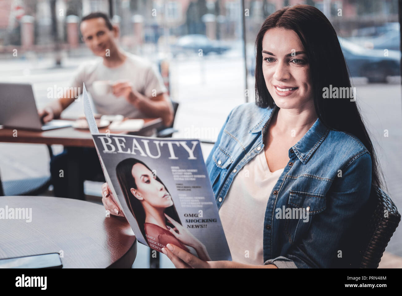 Attractive girl reading magazine hi-res stock photography and images ...