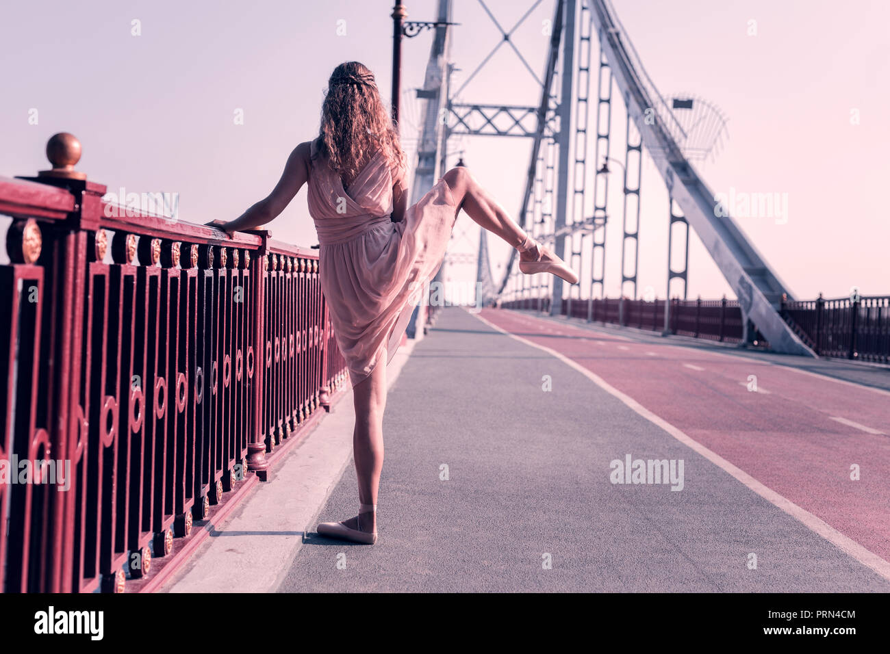 Professional nice woman lifting her leg up Stock Photo - Alamy