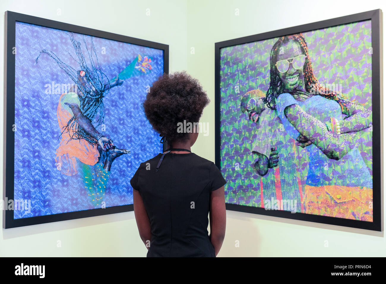 London, UK, 3rd Oct 2018. A gallery assistant poses with pieces by ...