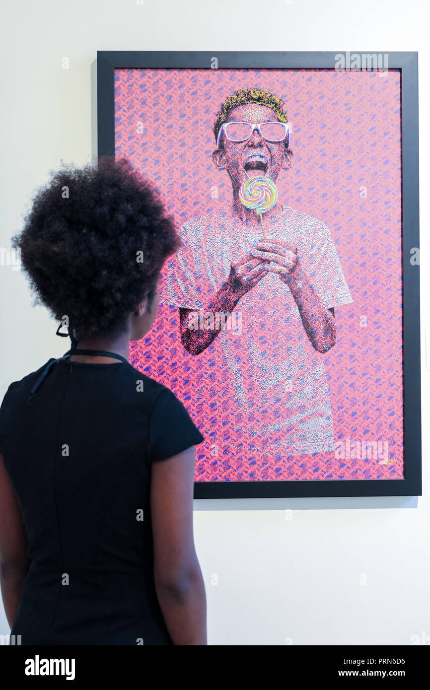 London, UK, 3rd Oct 2018. A gallery assistant poses with pieces by ...