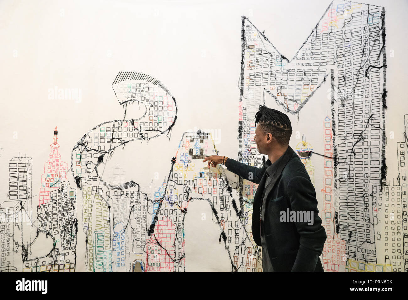 London, UK, 3rd Oct 2018. A gallery assistant expplains the story ...