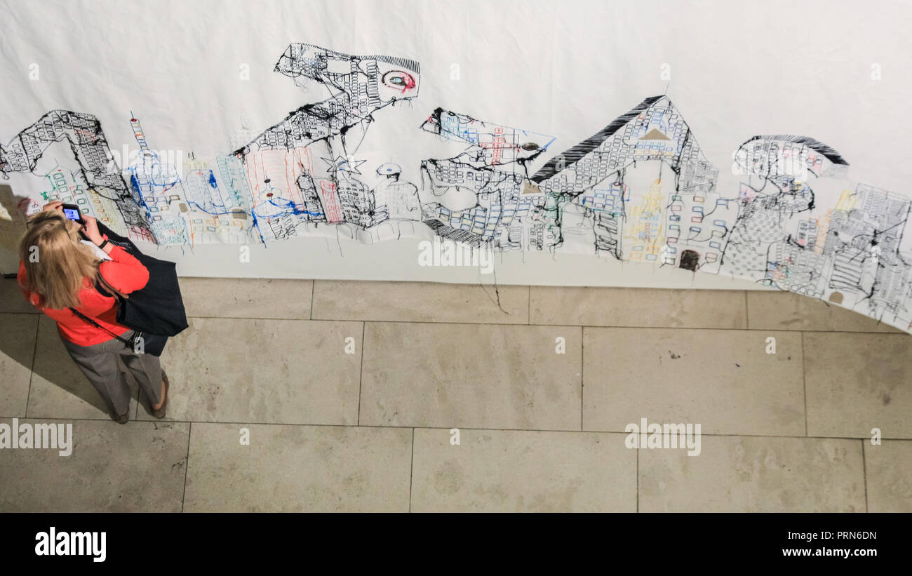 London, UK, 3rd Oct 2018. A visitor looks at Gastineau Massamba's ...