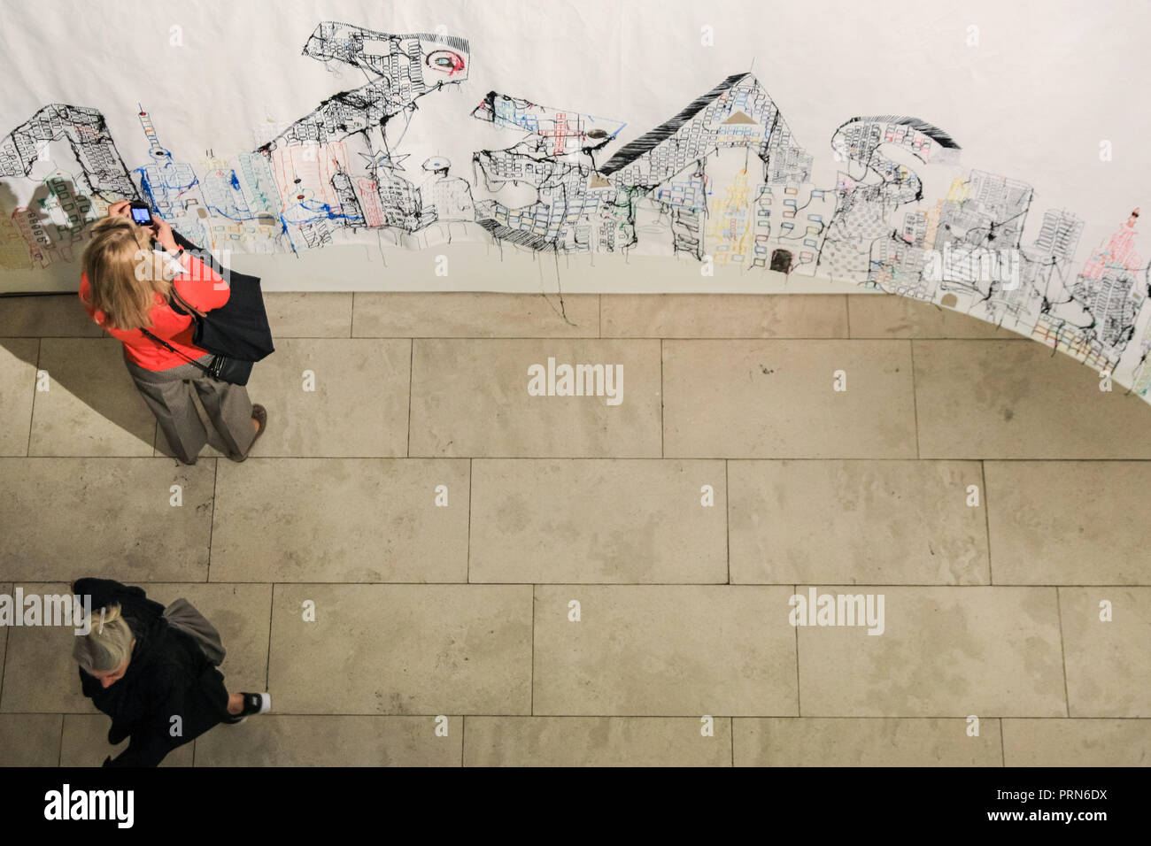 London, UK, 3rd Oct 2018. A visitor looks at Gastineau Massamba's ...