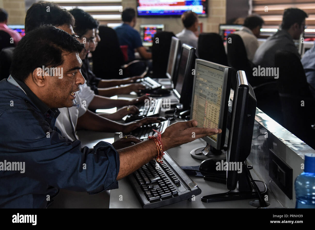 Mumbai, India. 4th Oct, 2018. Indian trader reacts at a local brokerage ...