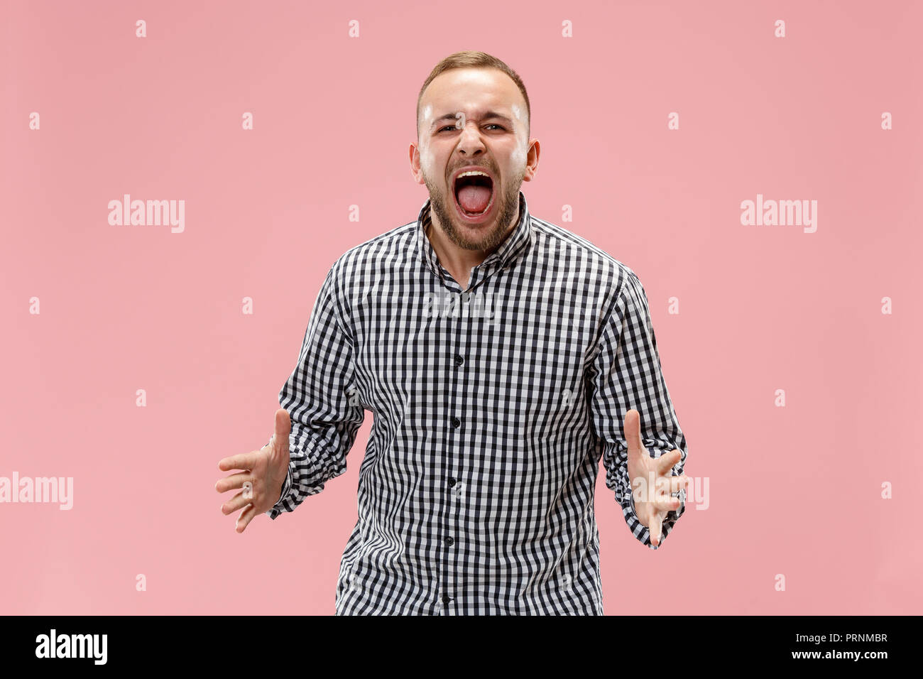 Screaming, hate, rage. Crying emotional angry man screaming on pink ...