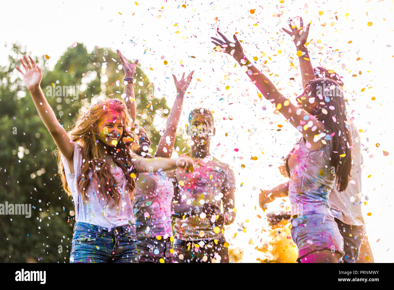 Group of happy friends playing with holi colors in a park - Young ...