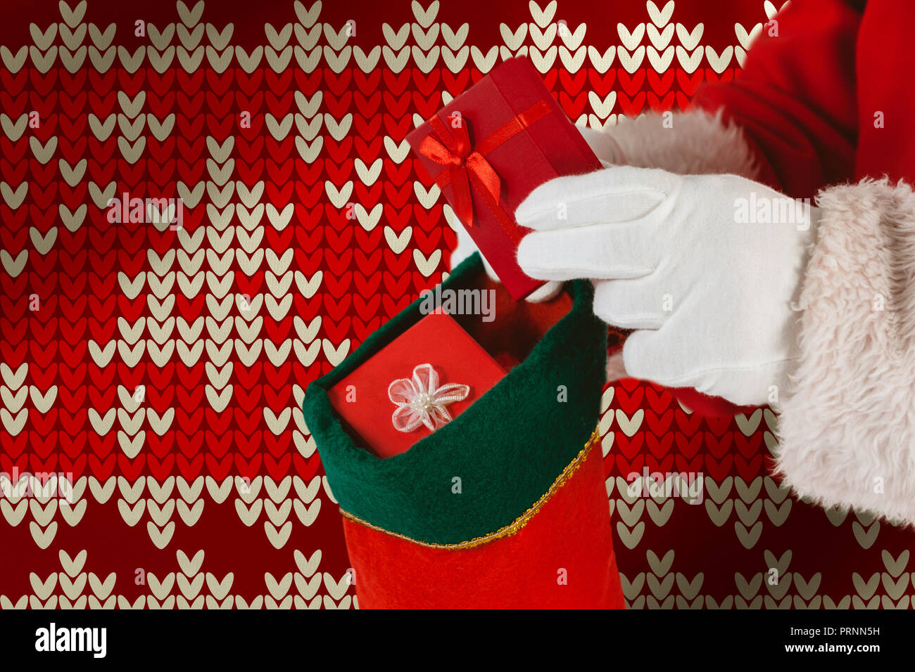 Composite image of santa claus putting presents in christmas stockings ...