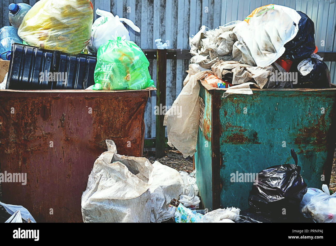 Litter box full of garbage in forest. Concept of ecology problem. Toned ...