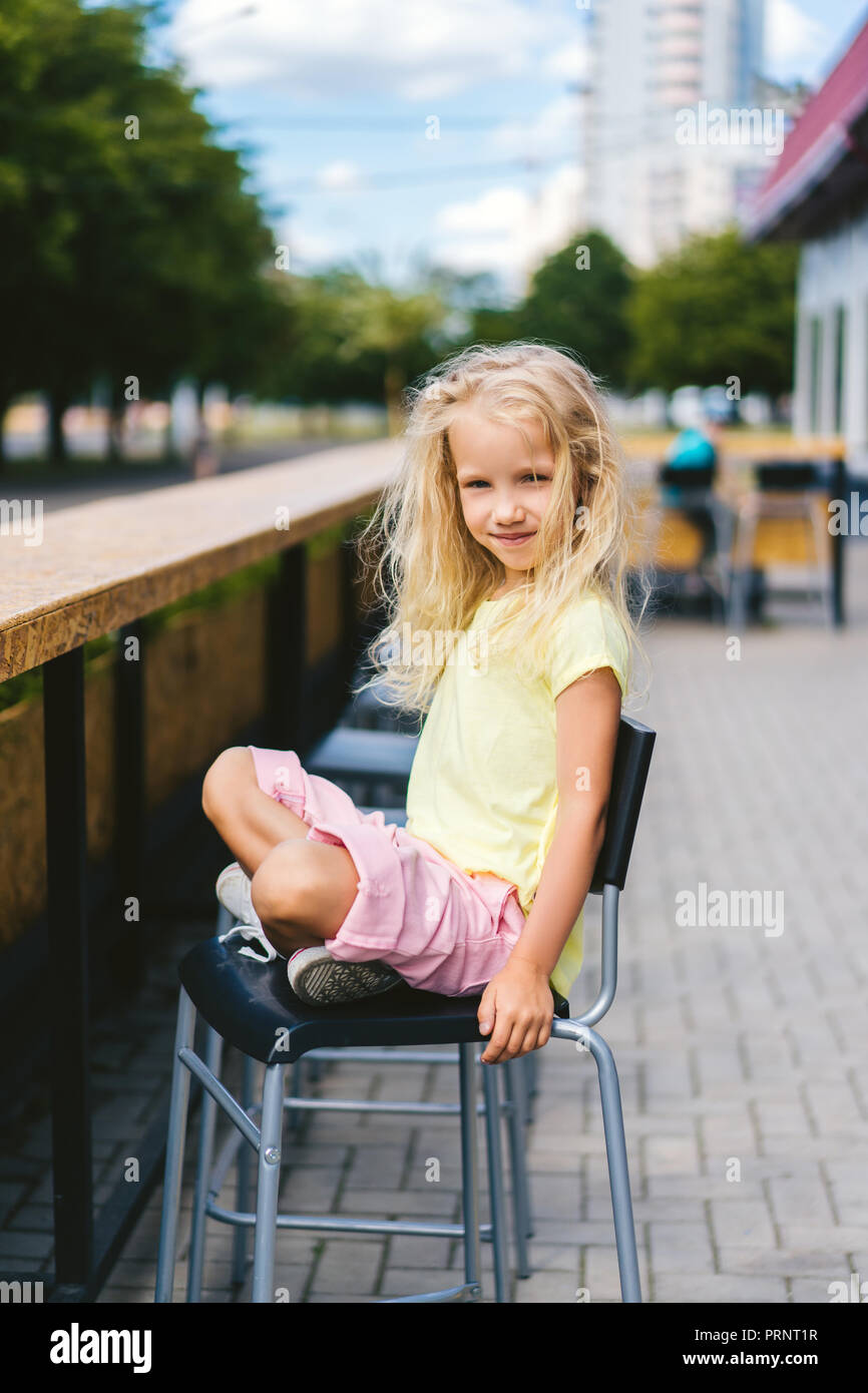 Child sitting on chair hi-res stock photography and images - Alamy