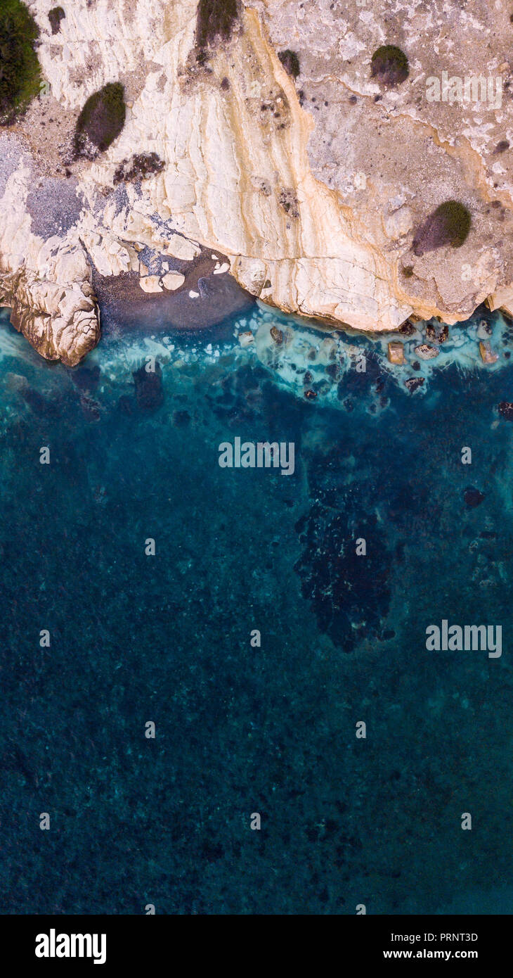 aerial view of beautiful sandstone rocks on seashore with blue water ...