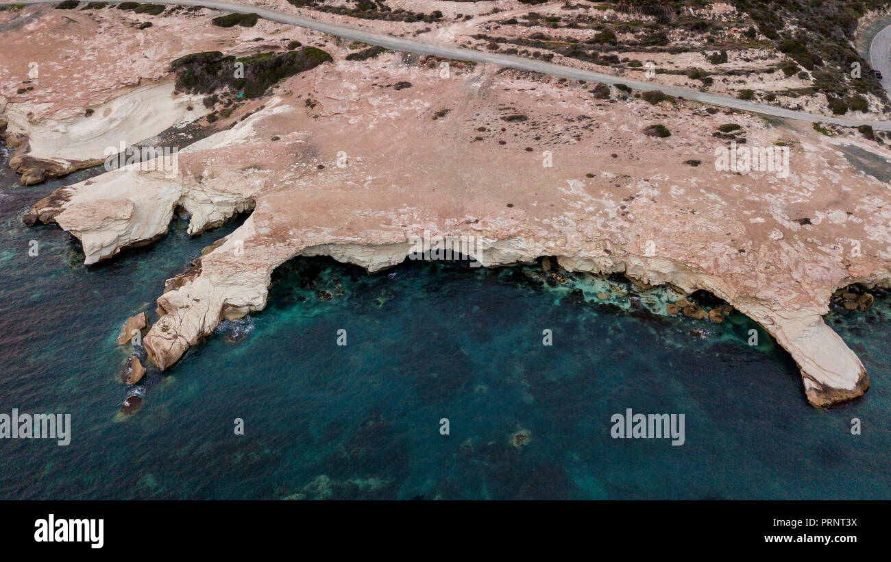 aerial view of sandstone rocks on seashore with blue water, Cyprus ...