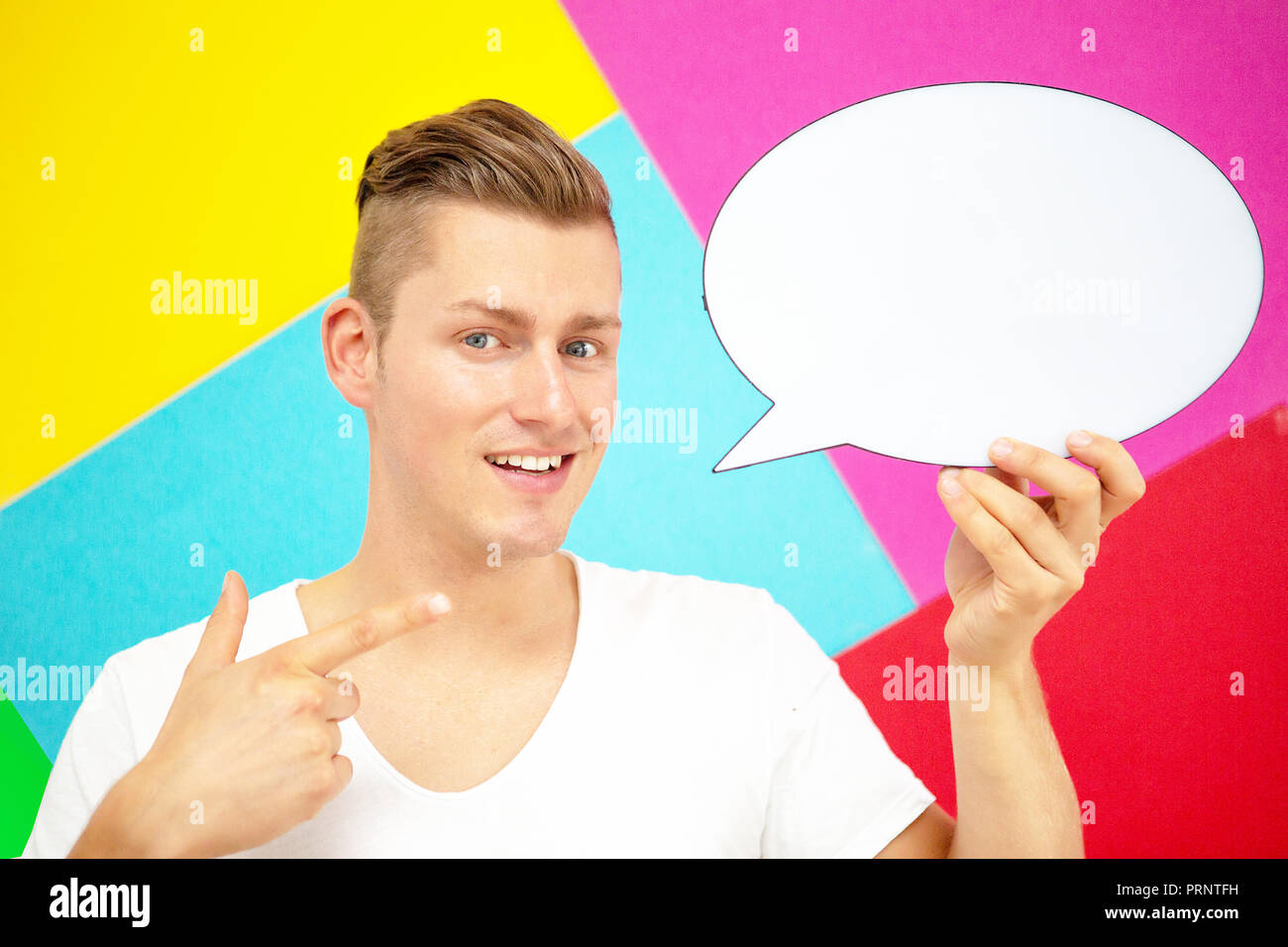 Young man is showing a speech bubble with text hi-res stock photography ...