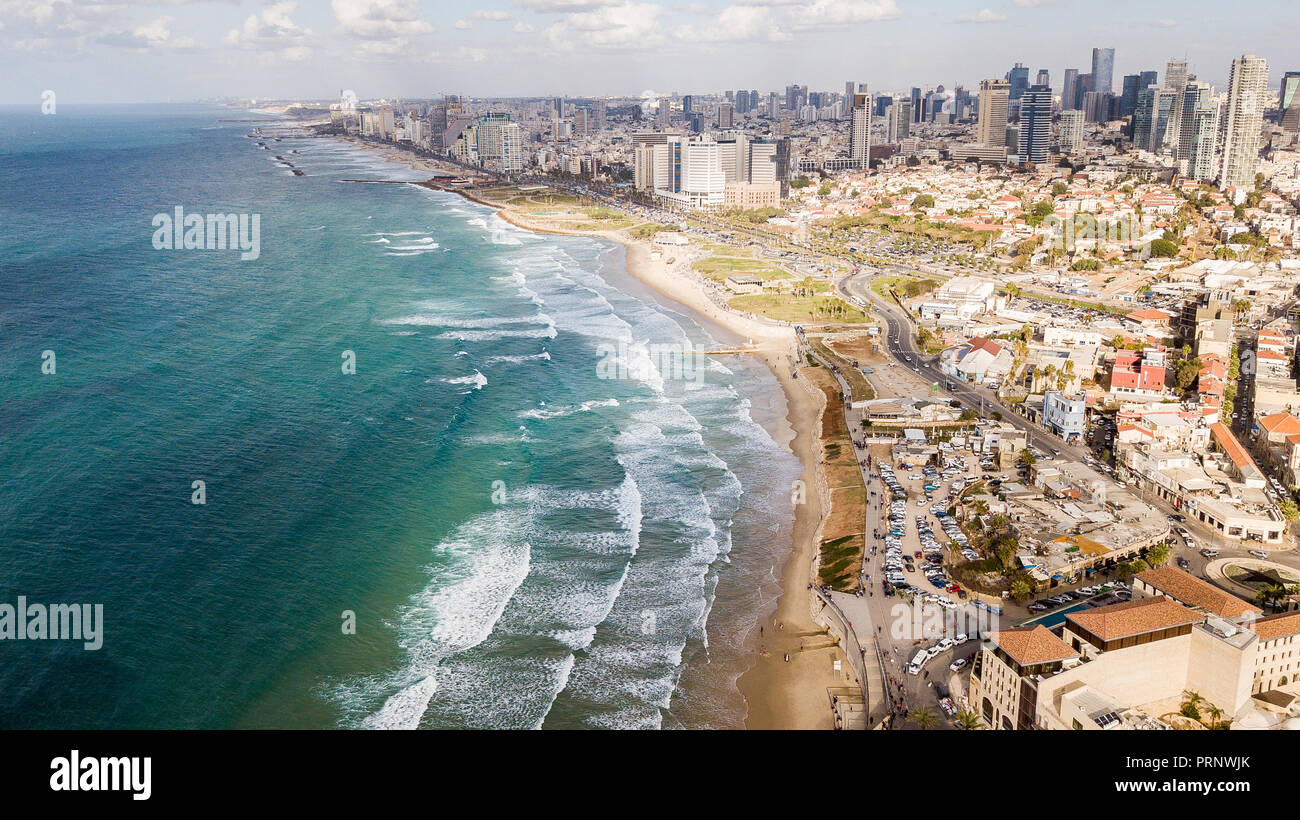 aerial view of big city with sandy seashore and wavy sea, Tel Aviv ...