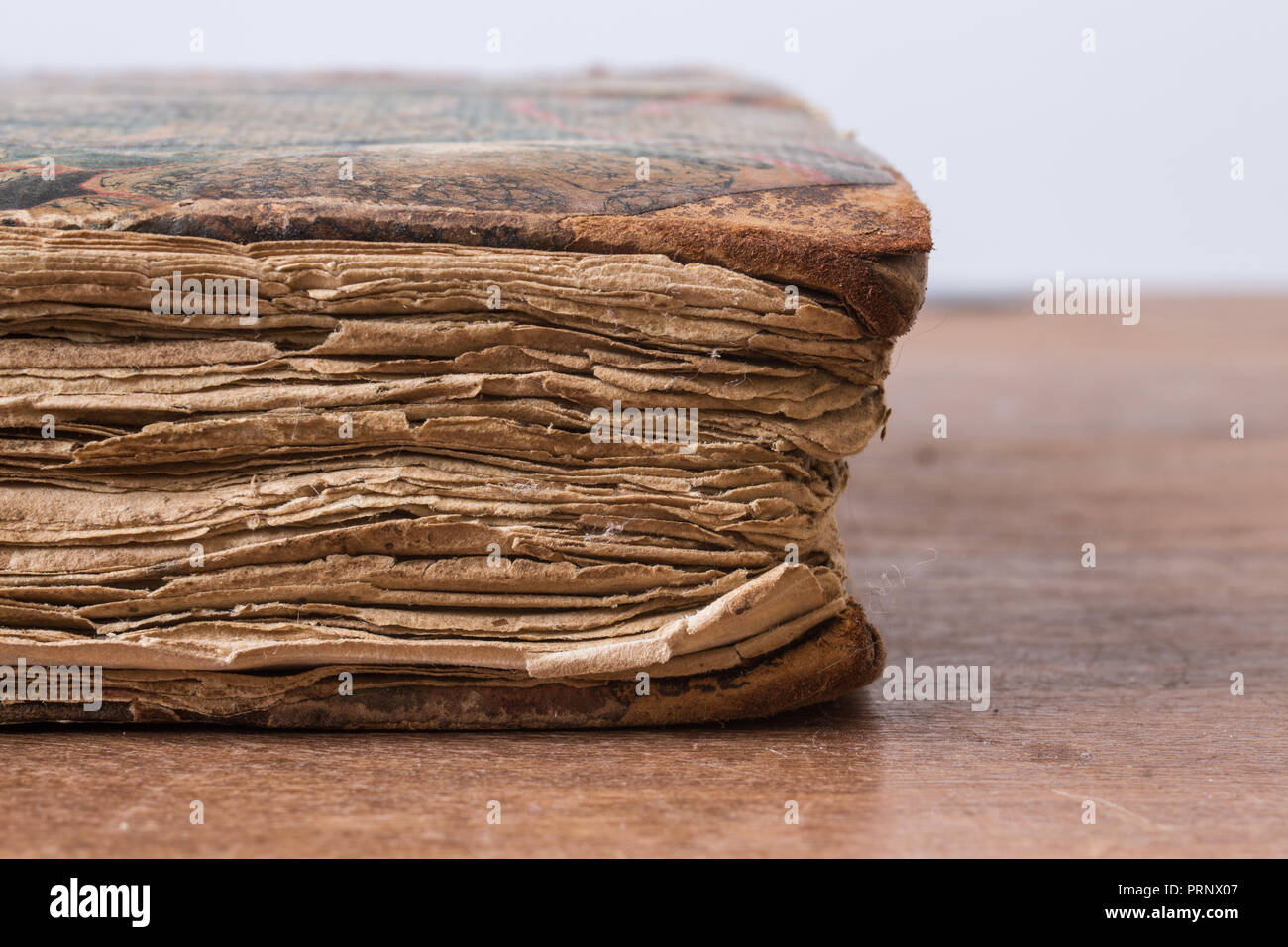 Closeup of an old vintage book corner with destressed wrinkled pages ...