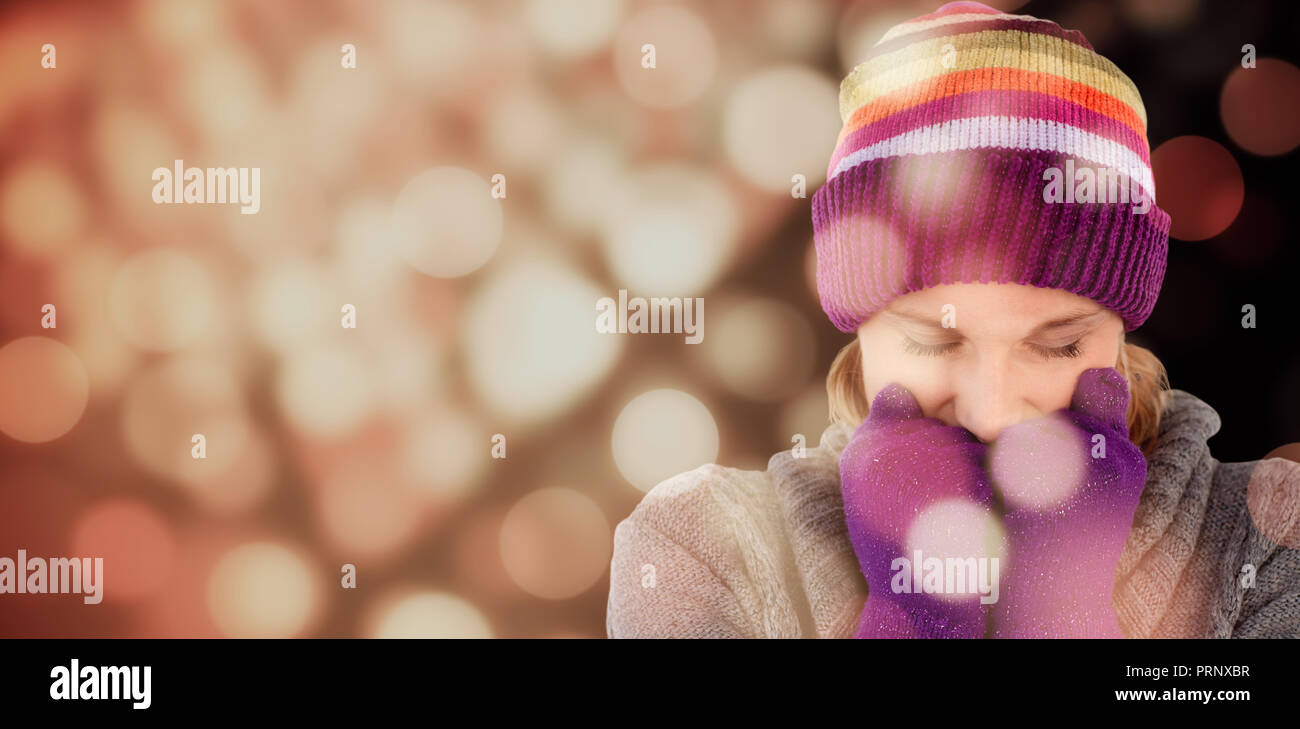 Composite image of freeze woman with gloves and a hat Stock Photo - Alamy