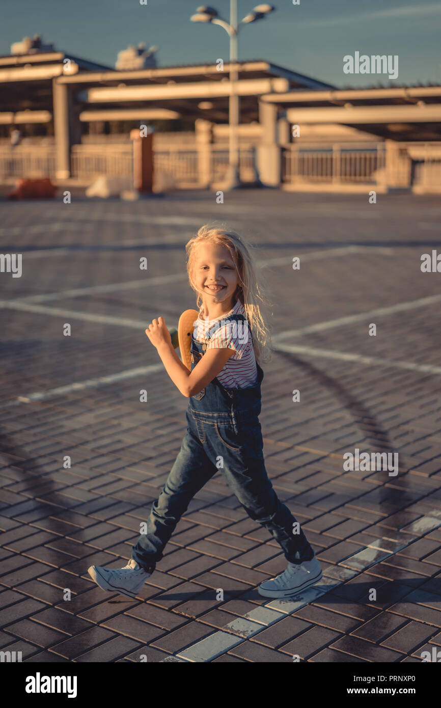 Kid walking smile looking camera hi-res stock photography and images ...