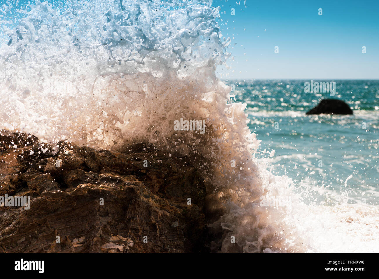 Wave breaking against rock hi-res stock photography and images - Alamy