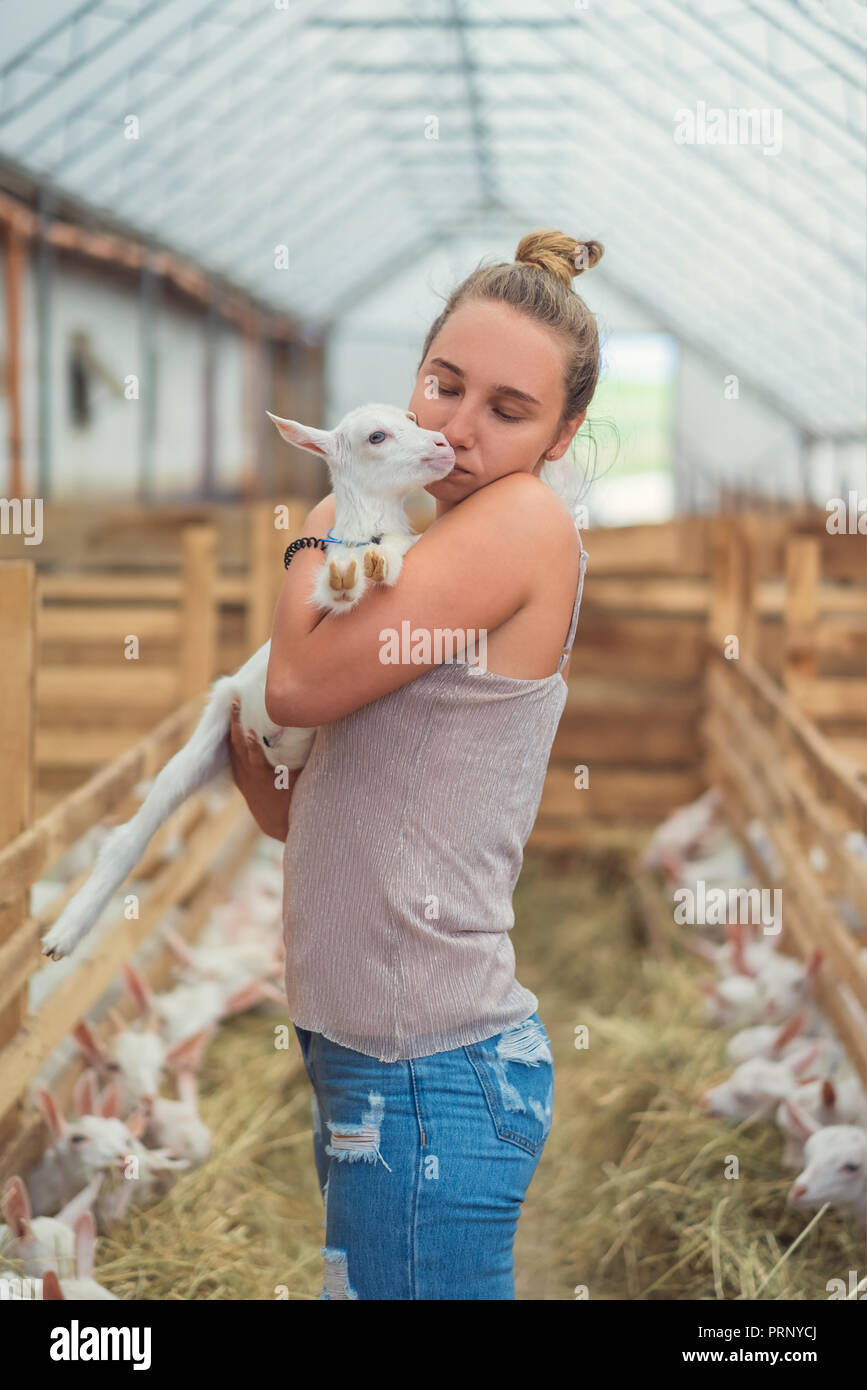 beautiful woman hugging and kissing goat at farm Stock Photo - Alamy