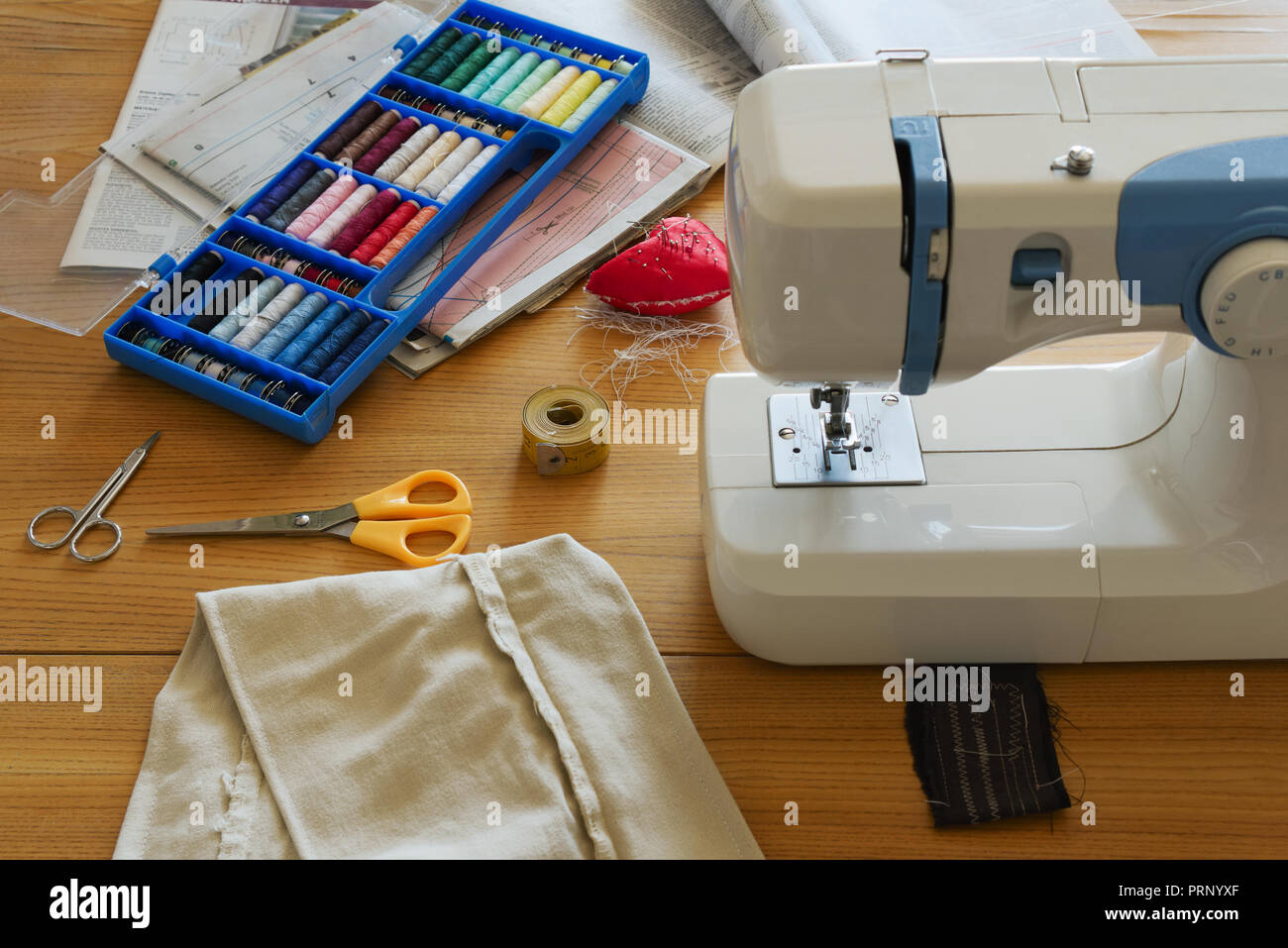 Sewing machine and sewing accessories on table Stock Photo - Alamy