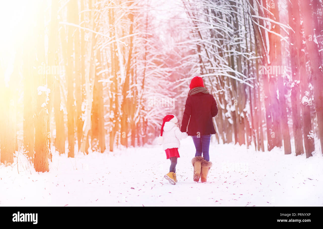 A winter fairy tale, a young mother and her daughter ride a sled Stock ...