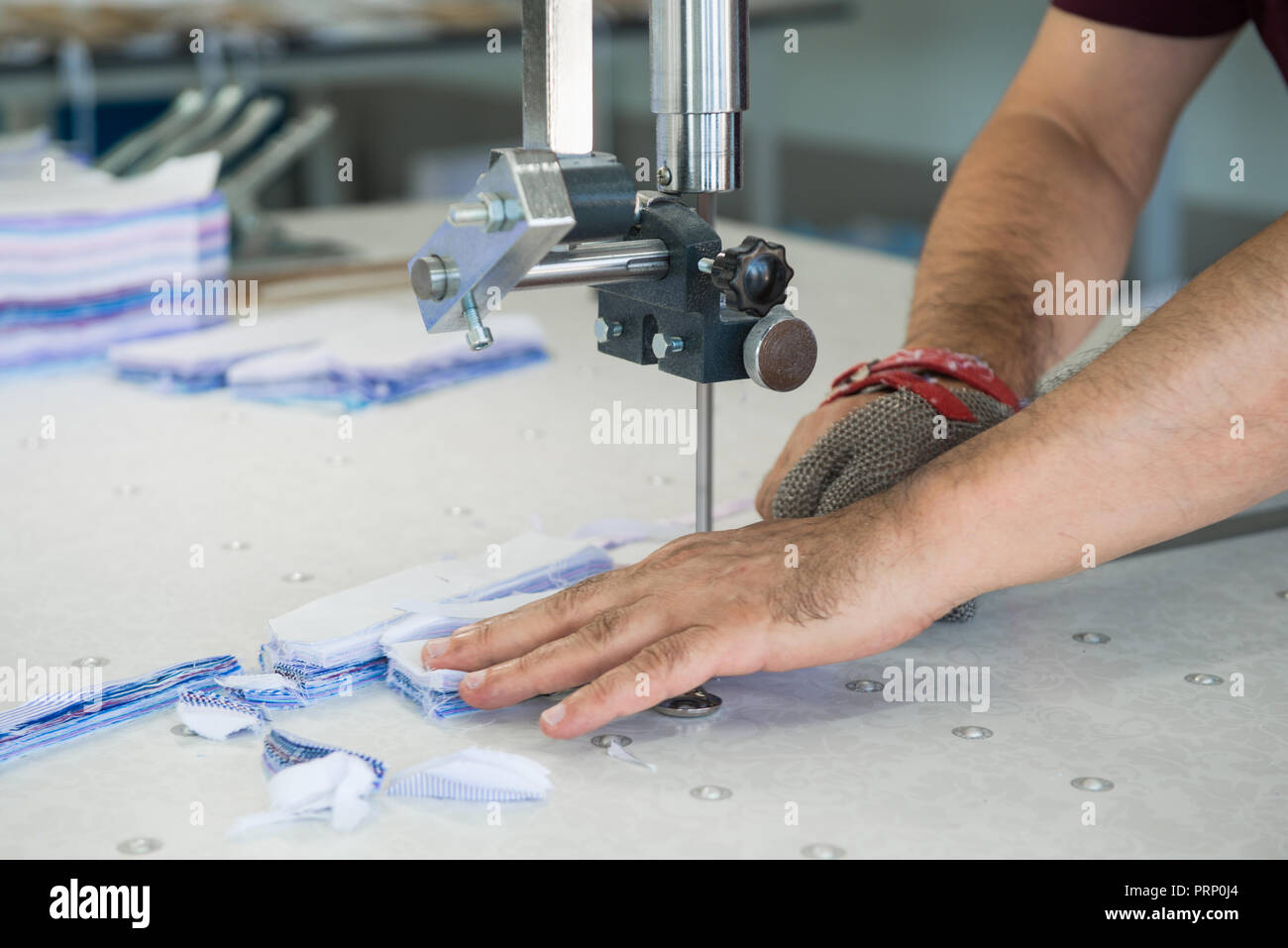 tailor with electric knife cut outs parts for sewing. industrial ...