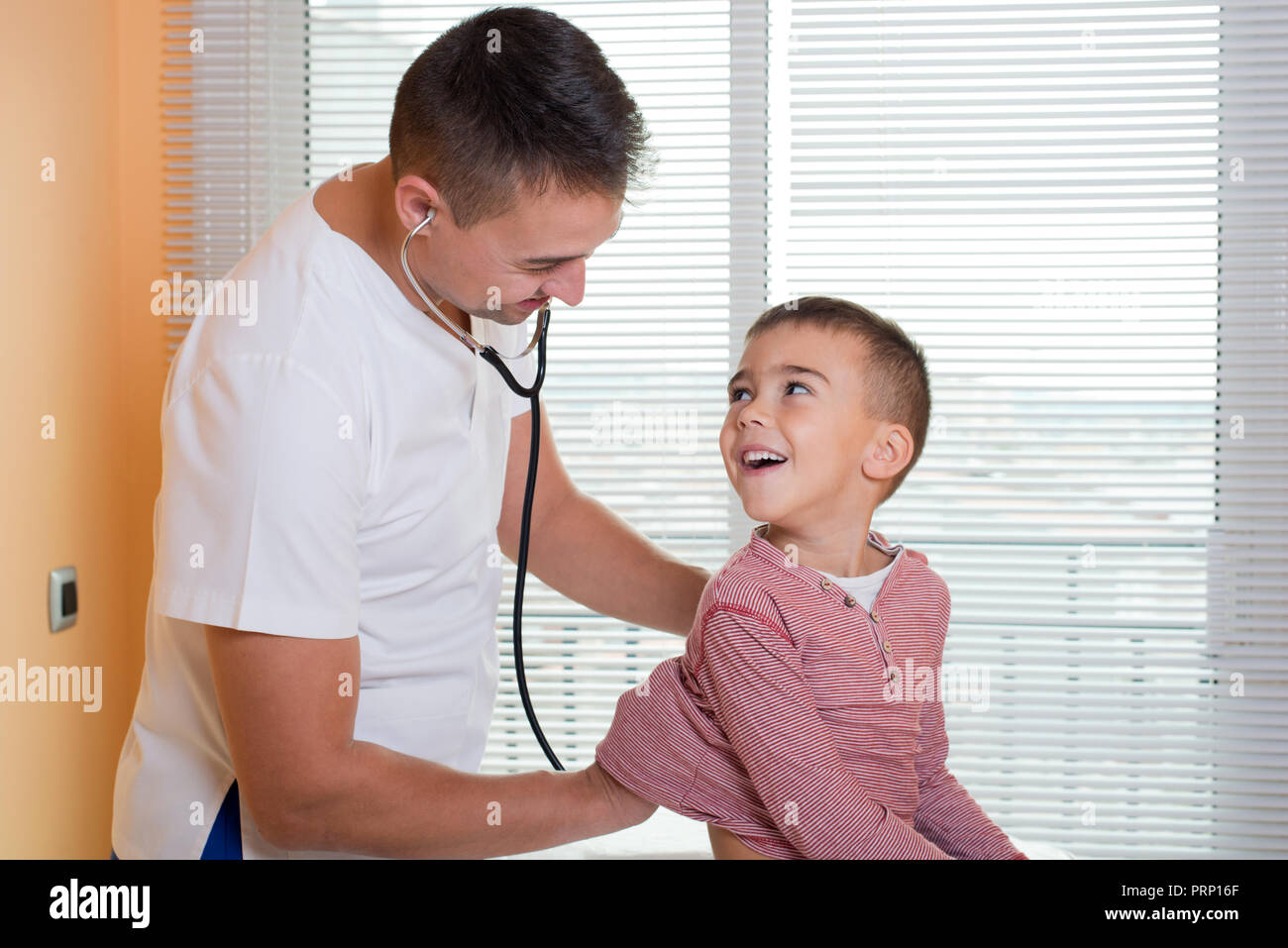 Doctor examines child in consultation Stock Photo - Alamy