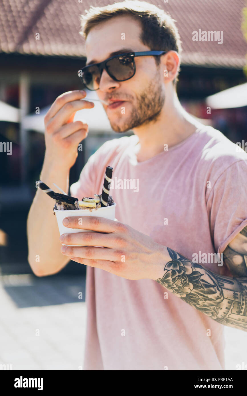 Handsome man eating sweet hi-res stock photography and images - Alamy