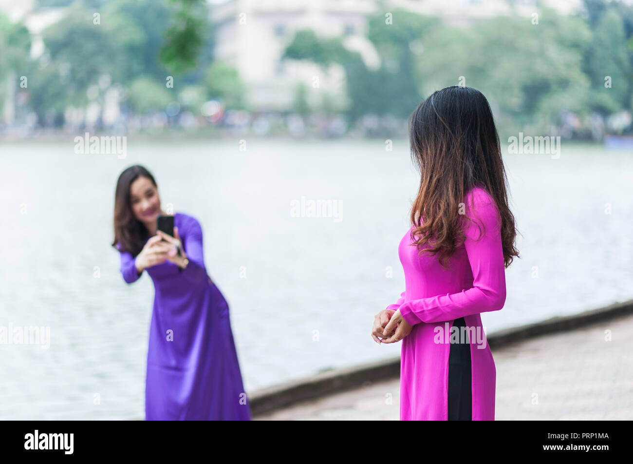 Hanoi, Vietnam - October 16, 2016. Young women in beautiful traditional ...