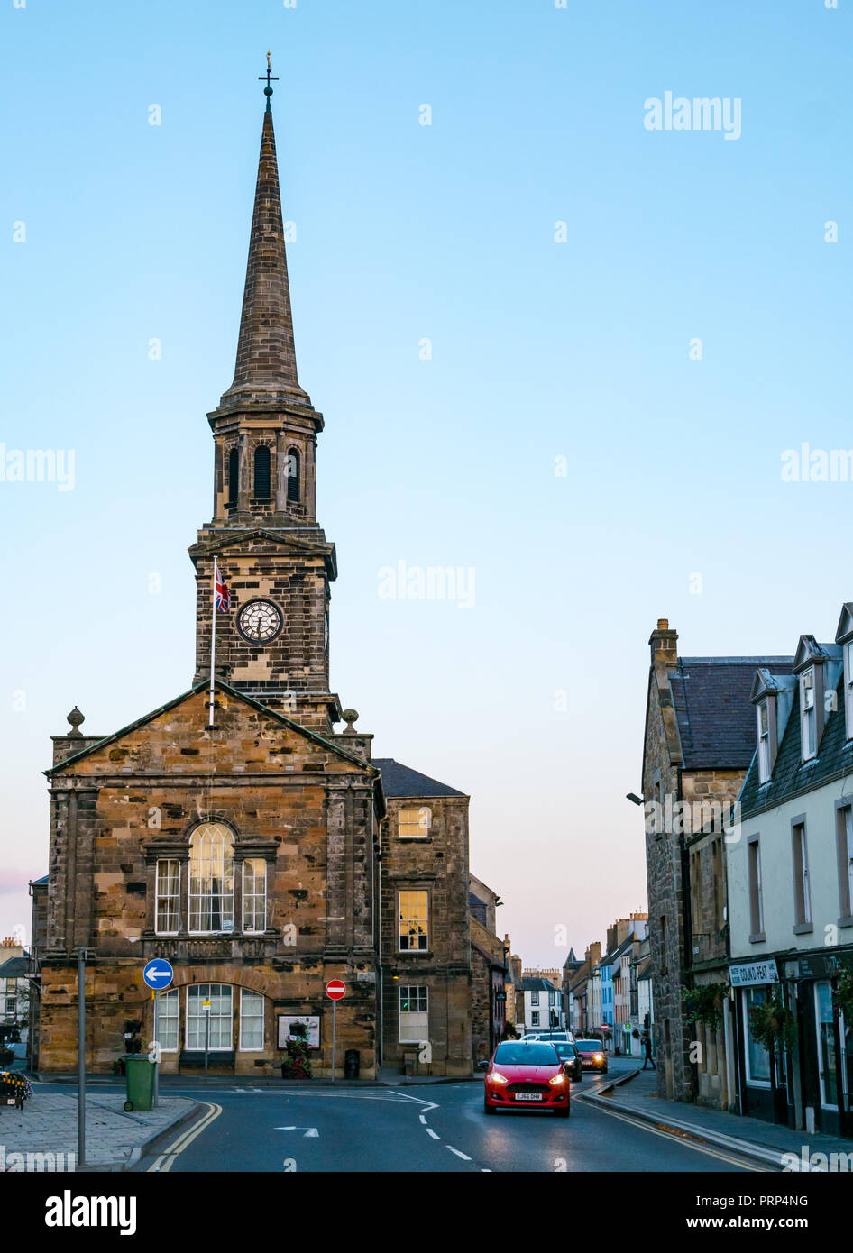 Haddington Town Hall spire and clock in reflected evening light ...