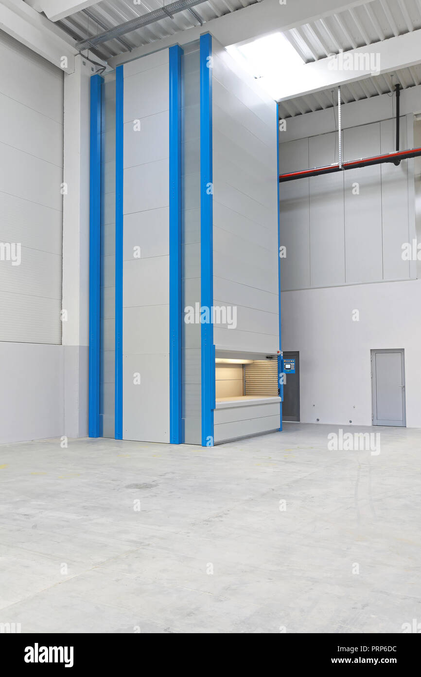 New vertical carousel unit in warehouse Stock Photo - Alamy