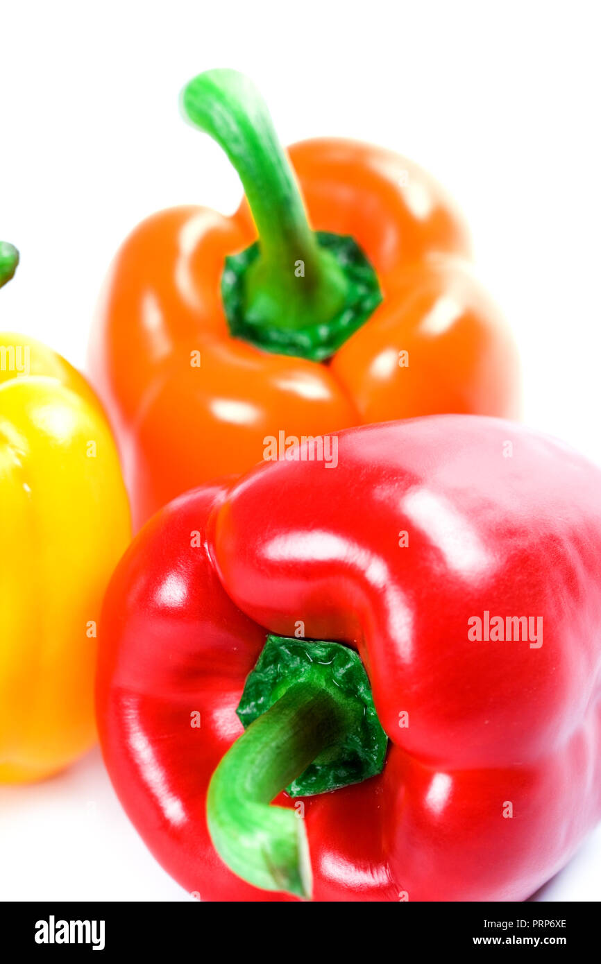 three bell peppers closeup on white background Stock Photo - Alamy