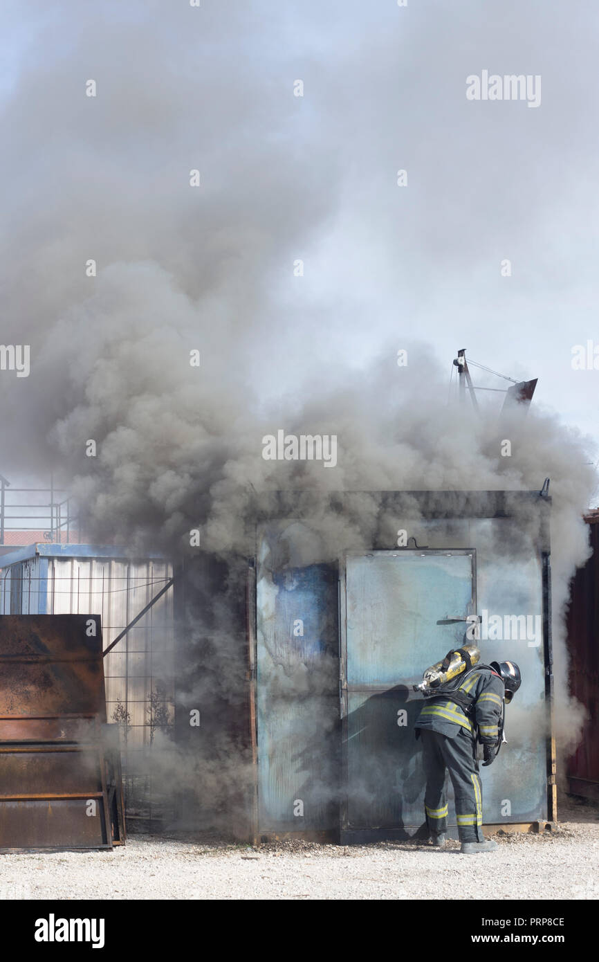 Firefighter putting out fire training station extinguisher backdraft ...