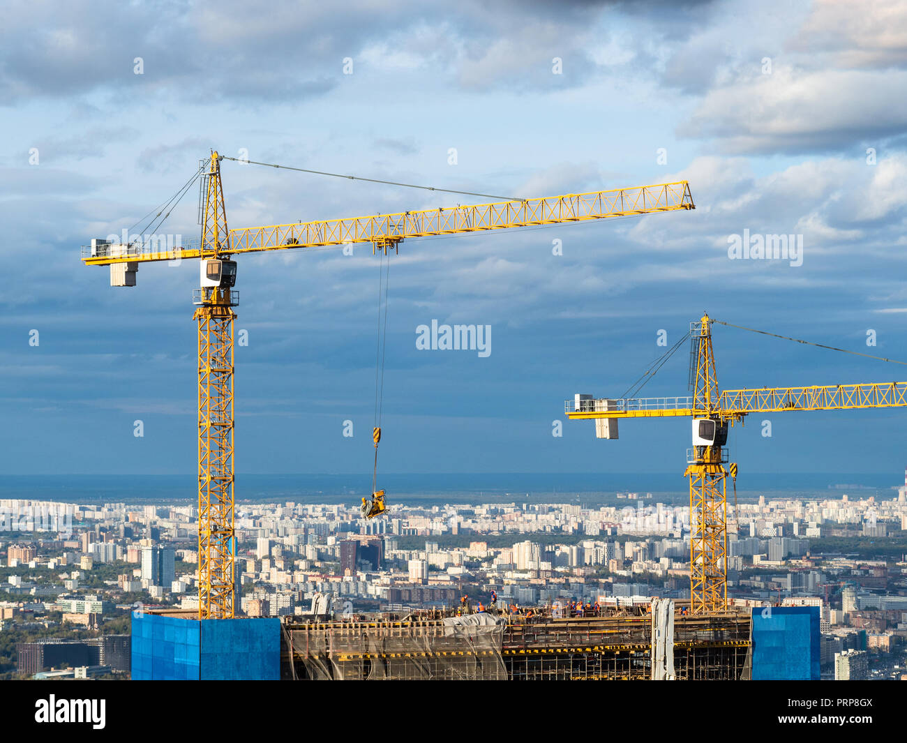 above view of cranes on construction site of skyscraper in Moscow city ...