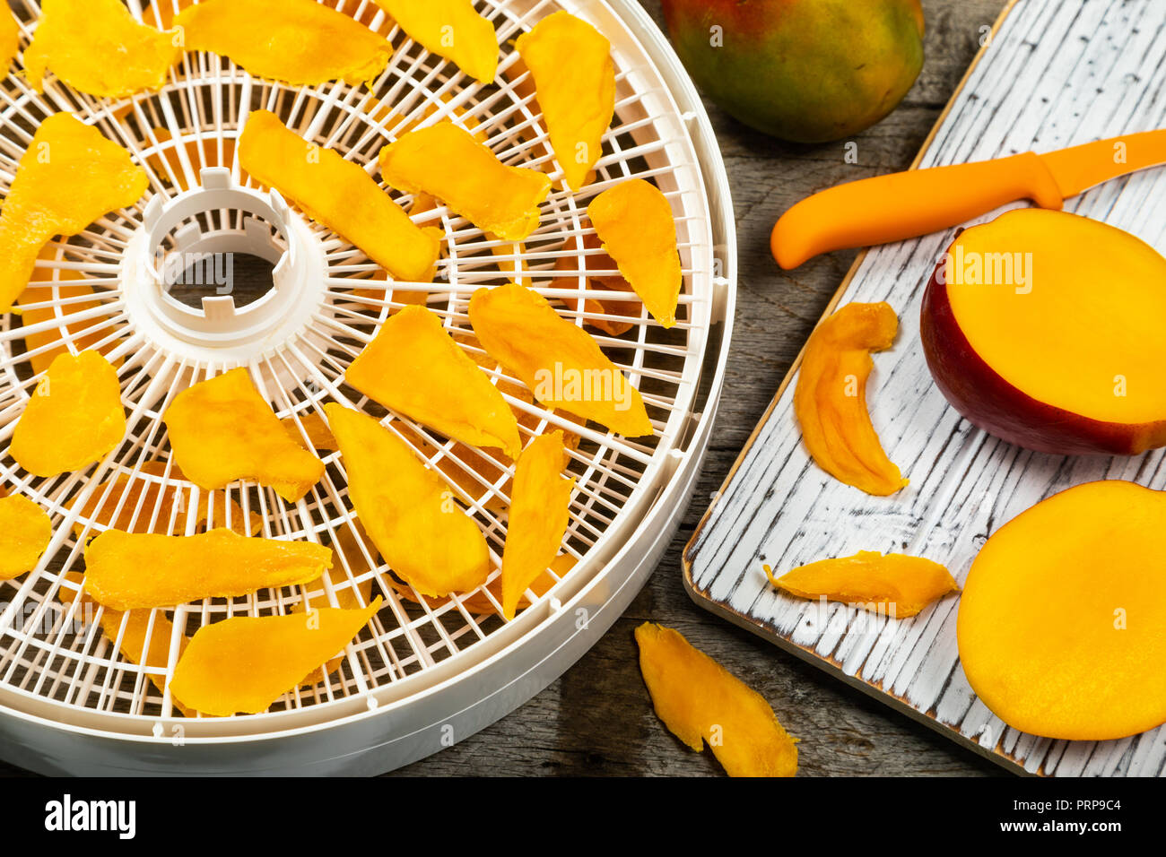 Dried Mango Fruit on a Dehydrator Rack Stock Photo - Alamy