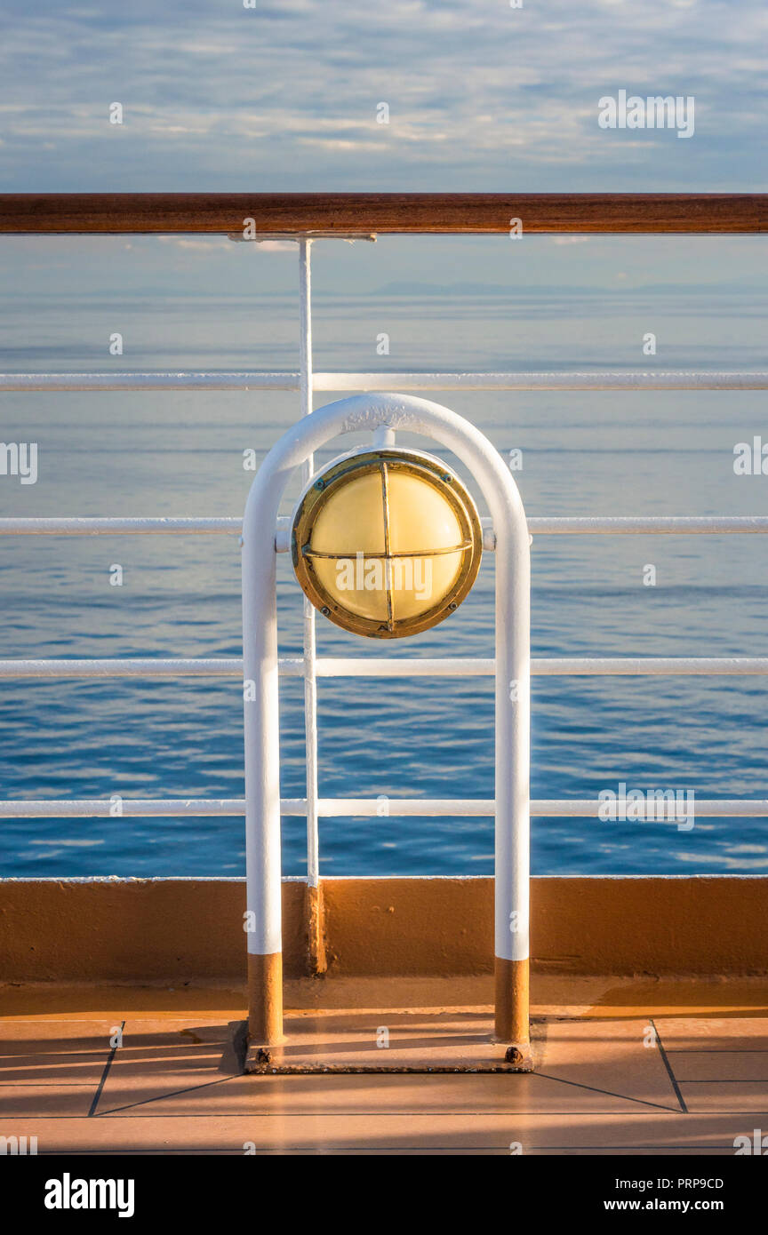 Nautical deck light with brass metal fitting aboard cruise ship in late ...