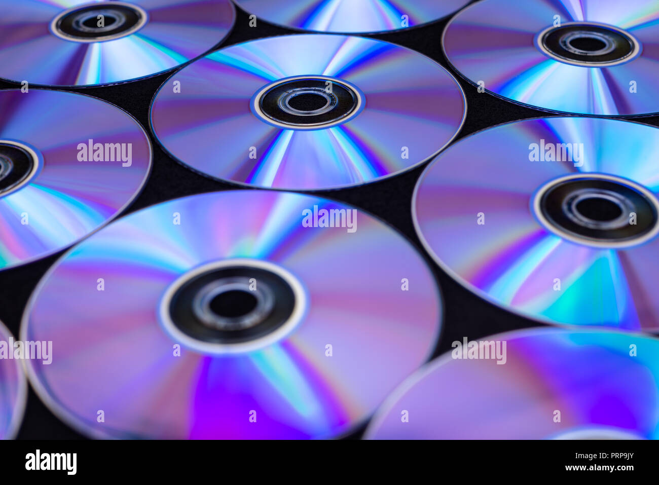 CDs / DVDs lying on a black background with reflections of light Stock ...