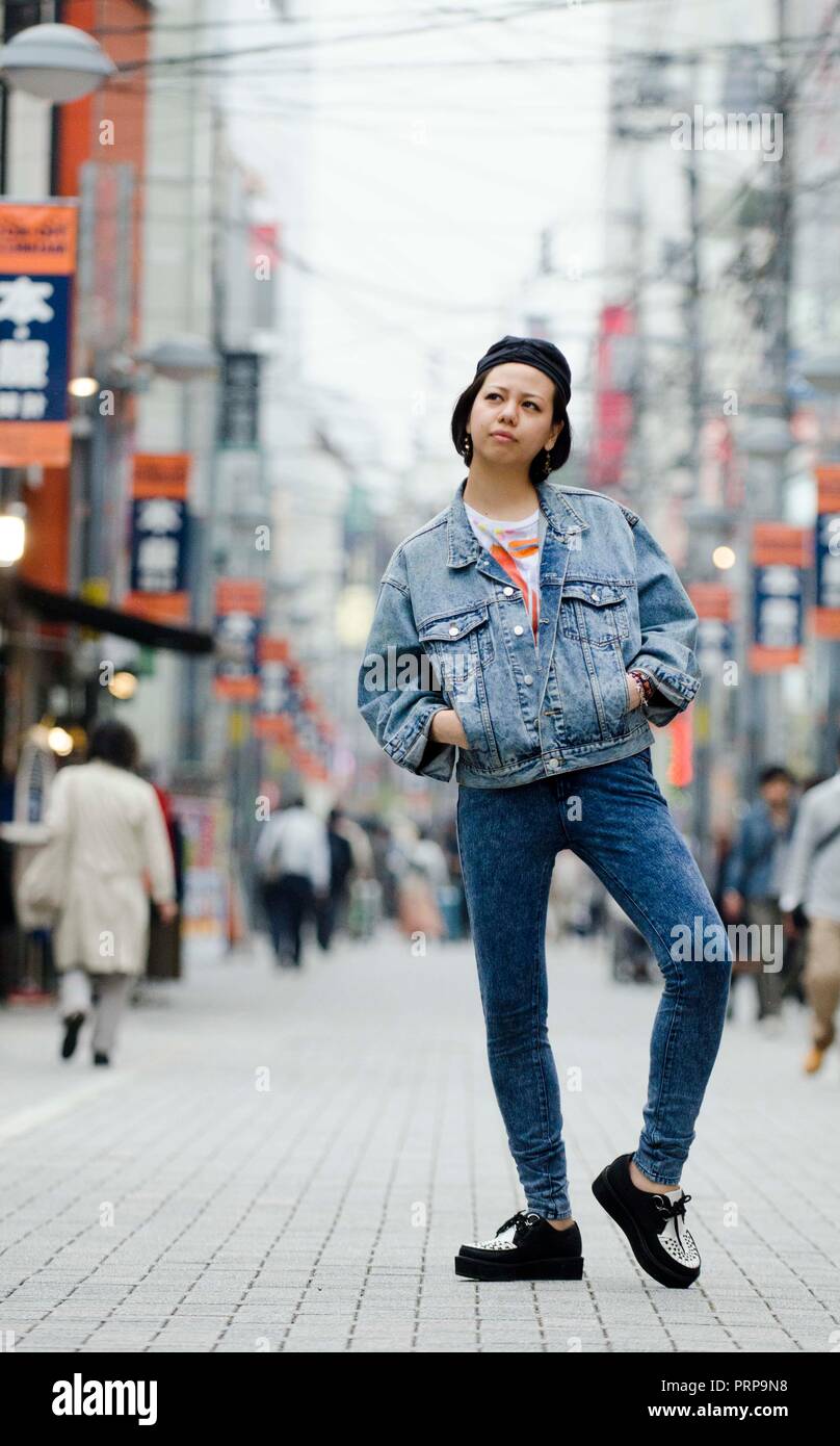 Japanese Girl poses on the street in Machida, Japan. Machida is an area ...
