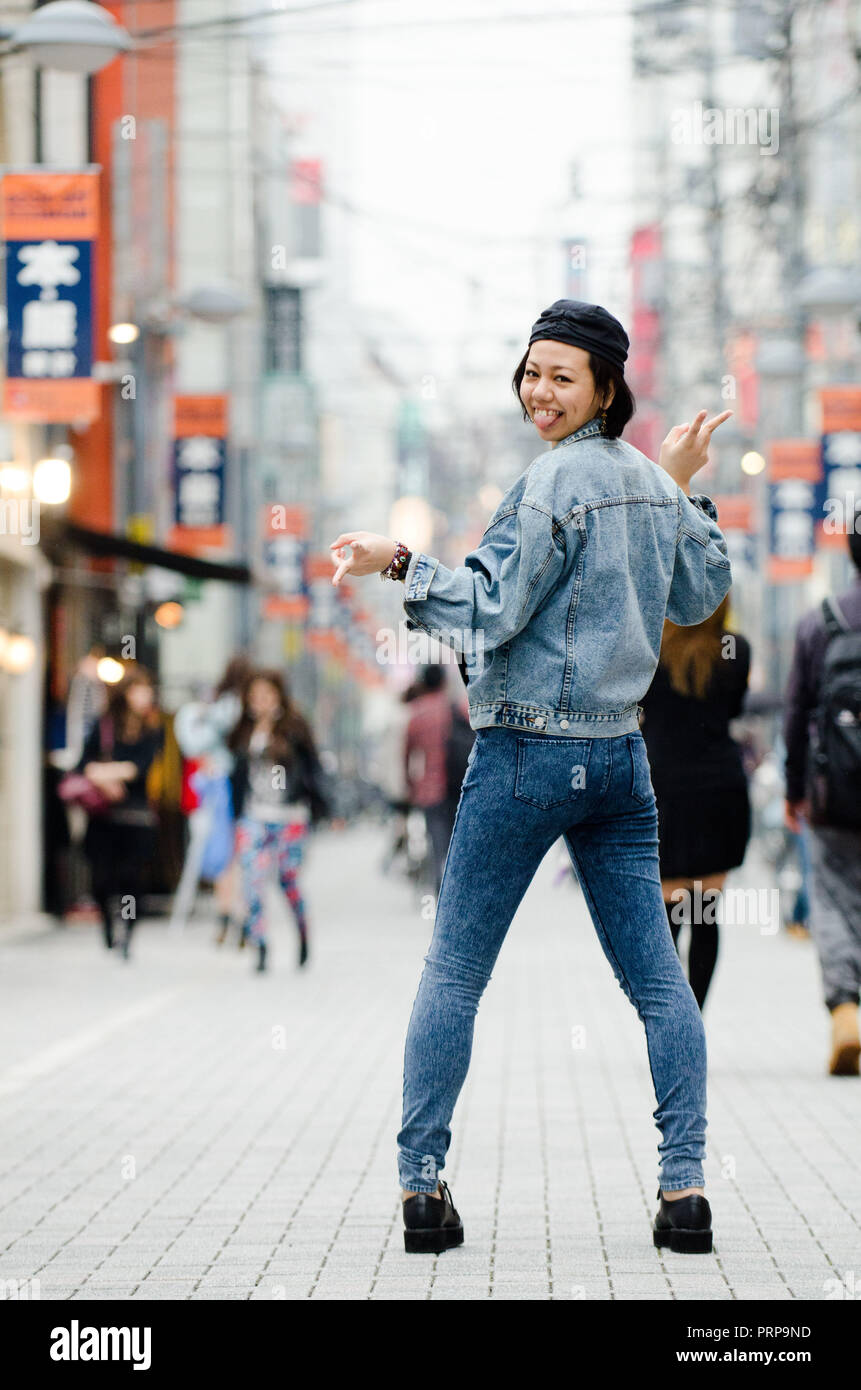 Japanese Girl poses on the street in Machida, Japan. Machida is an area ...