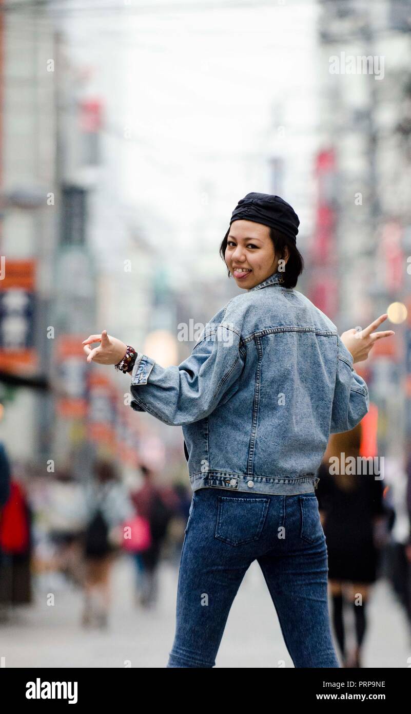 Japanese Girl poses on the street in Machida, Japan. Machida is an area ...
