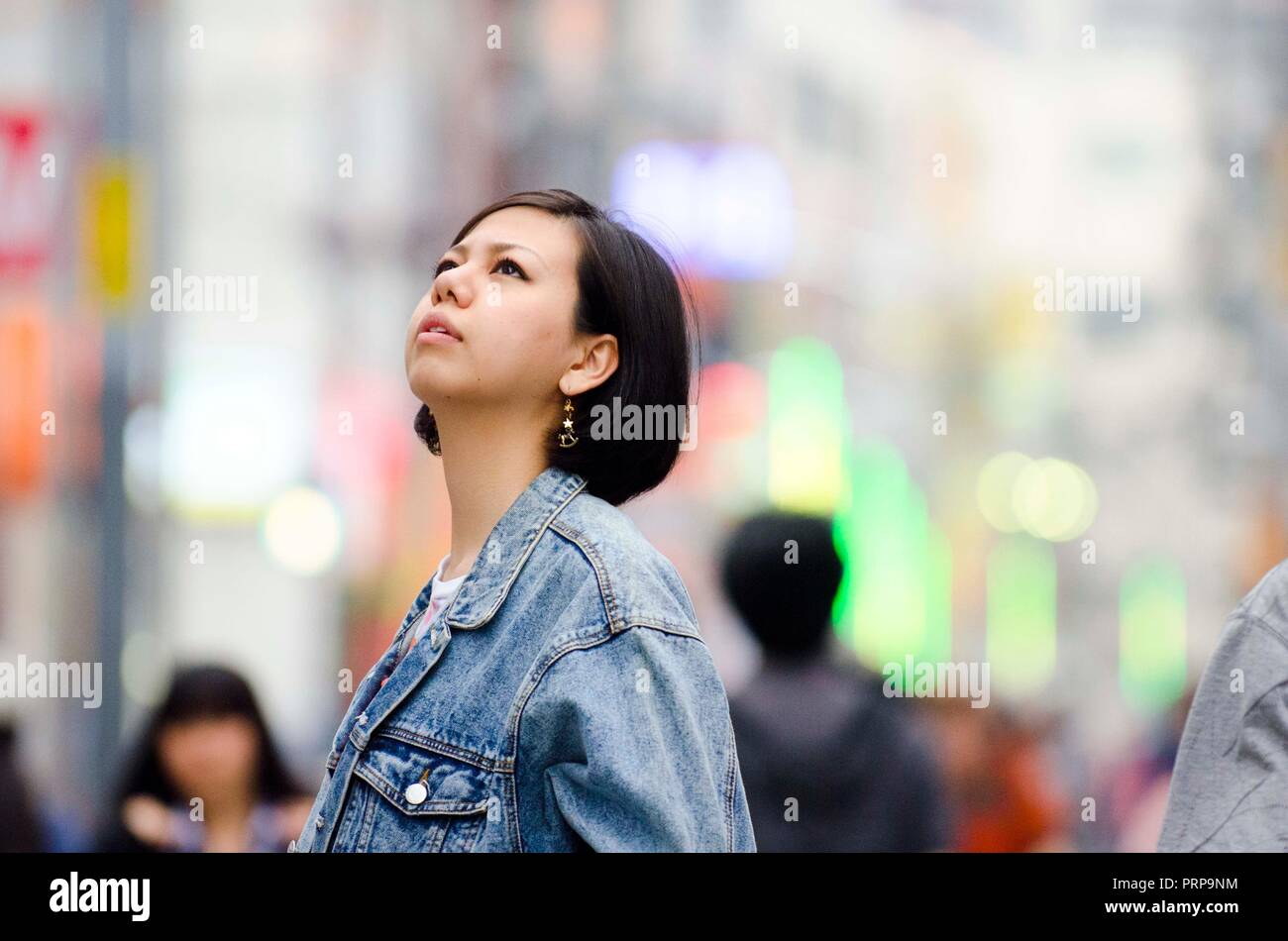 Japanese Girl poses on the street in Machida, Japan. Machida is an area ...