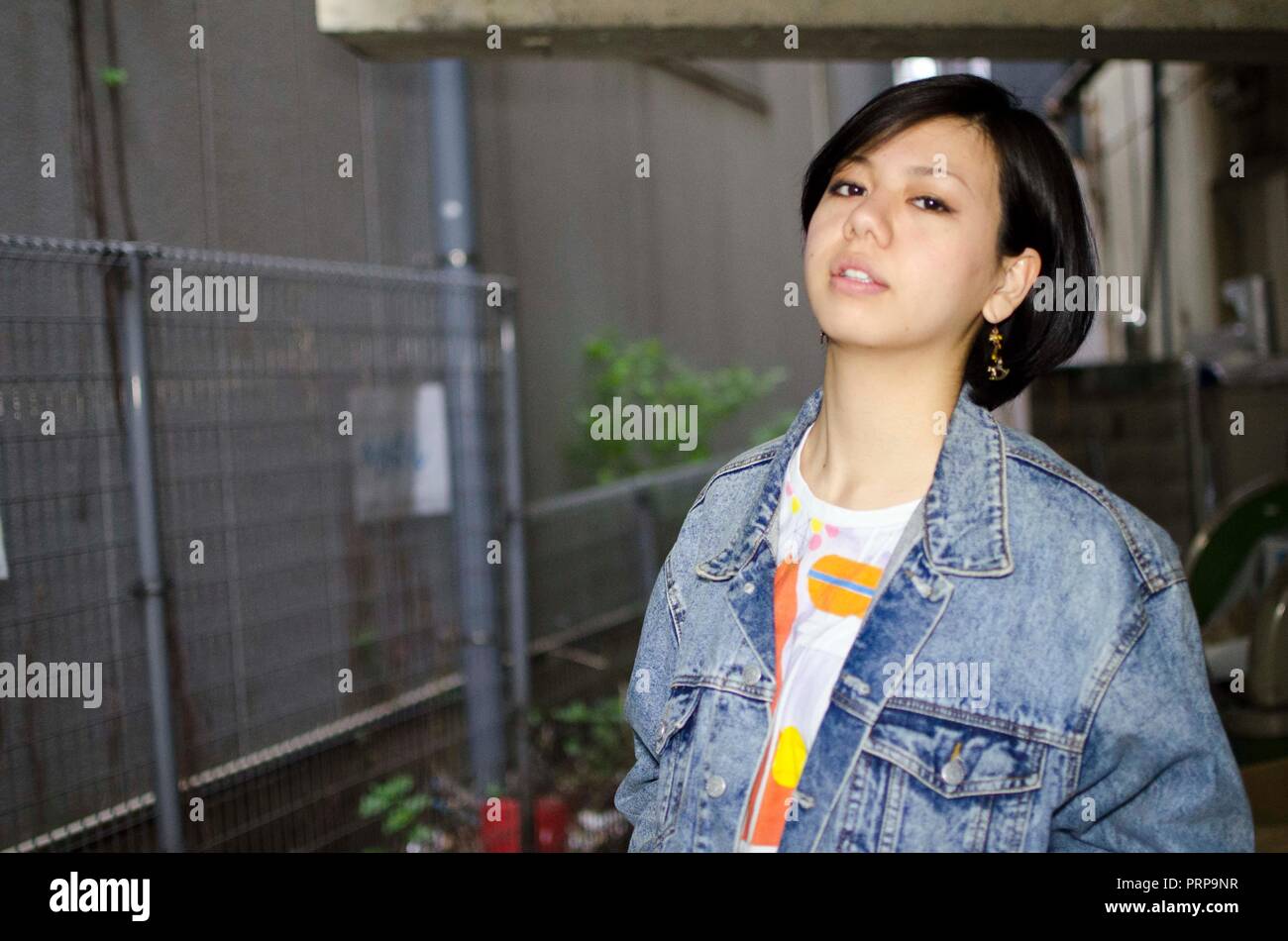 Japanese Girl poses on the street in Machida, Japan. Machida is an area ...