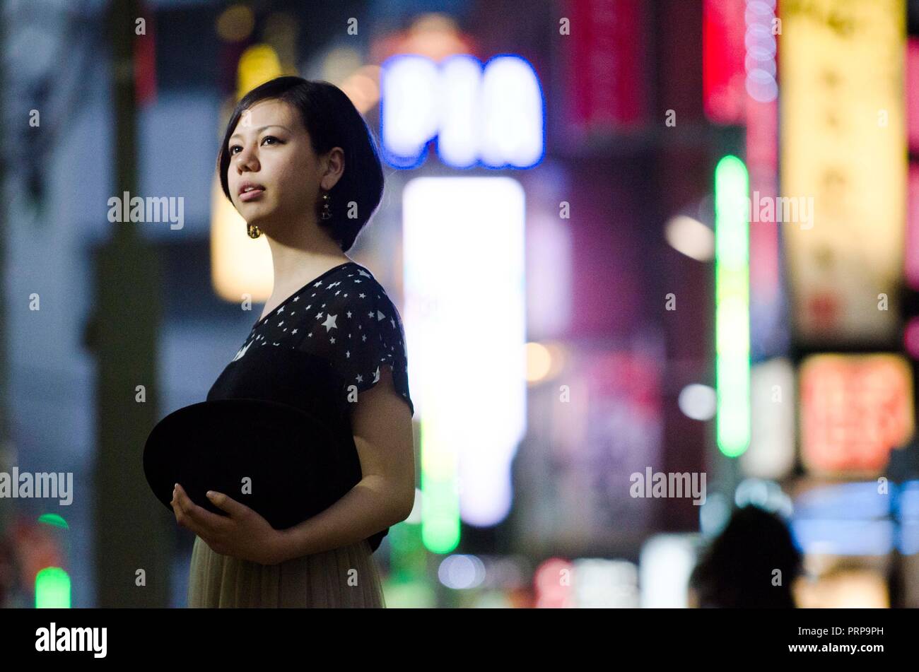 Japanese Girl poses on the street in Machida, Japan. Machida is an area ...