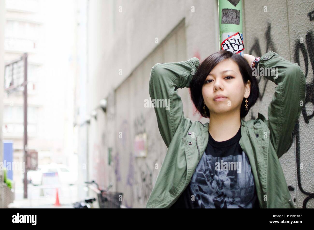 Japanese Girl poses on the street in Machida, Japan. Machida is an area ...