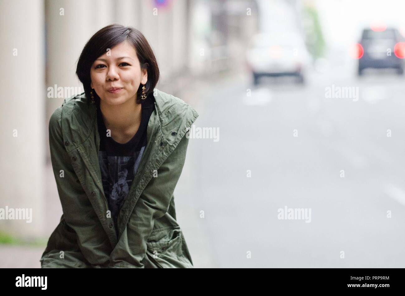 Japanese Girl poses on the street in Machida, Japan. Machida is an area ...