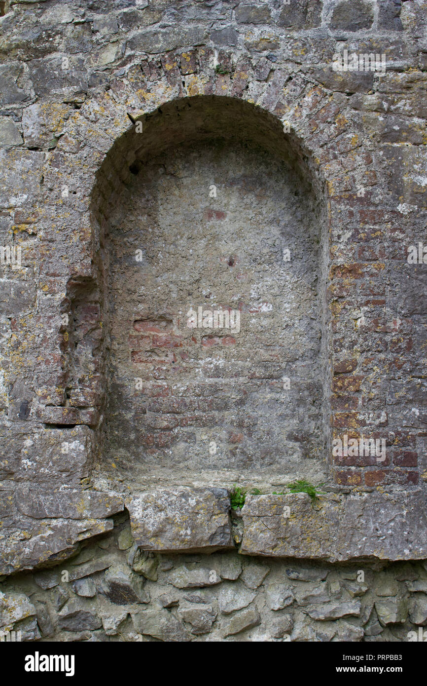 View of a bricked-in arched stone window in a medieval castle ruin in ...